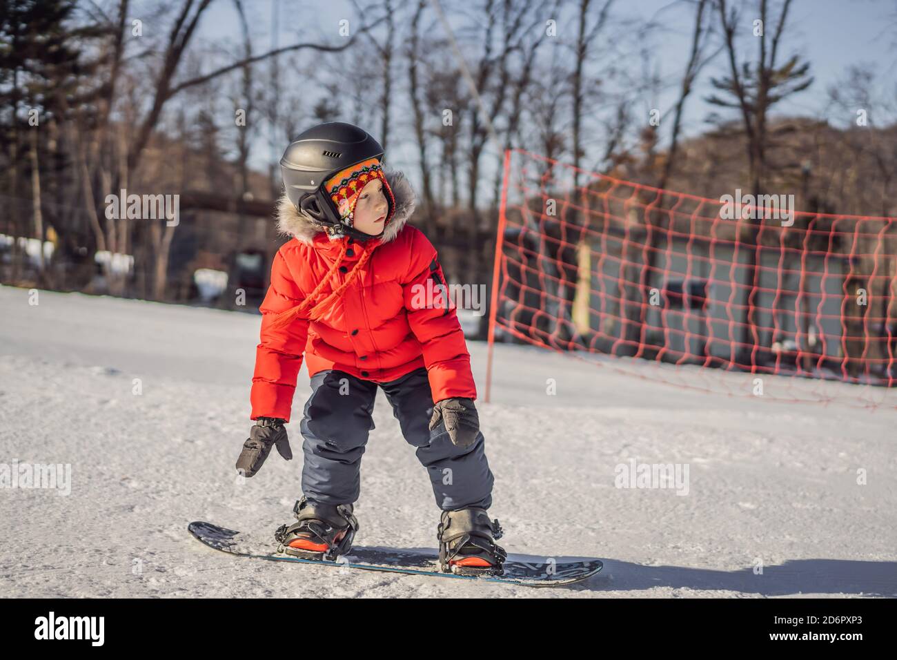 Little cute boy snowboarding. Activities for children in winter ...