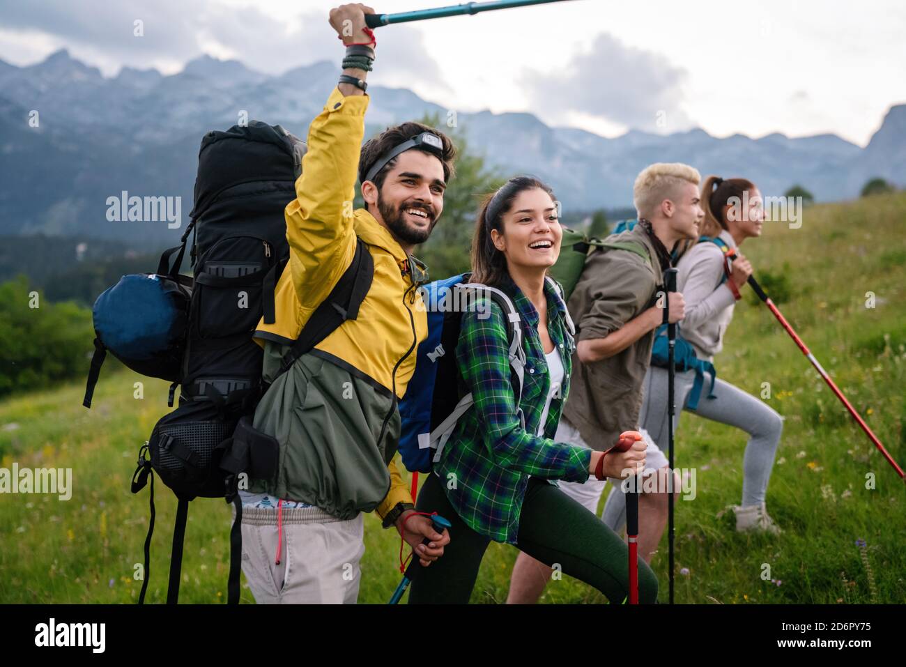 Group of friends hiking together outdoors exploring the wilderness and ...