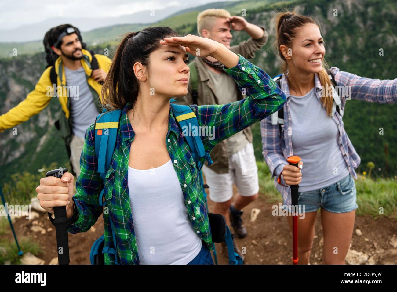 Hiking with friends is so fun. Group of young people with backpacks ...