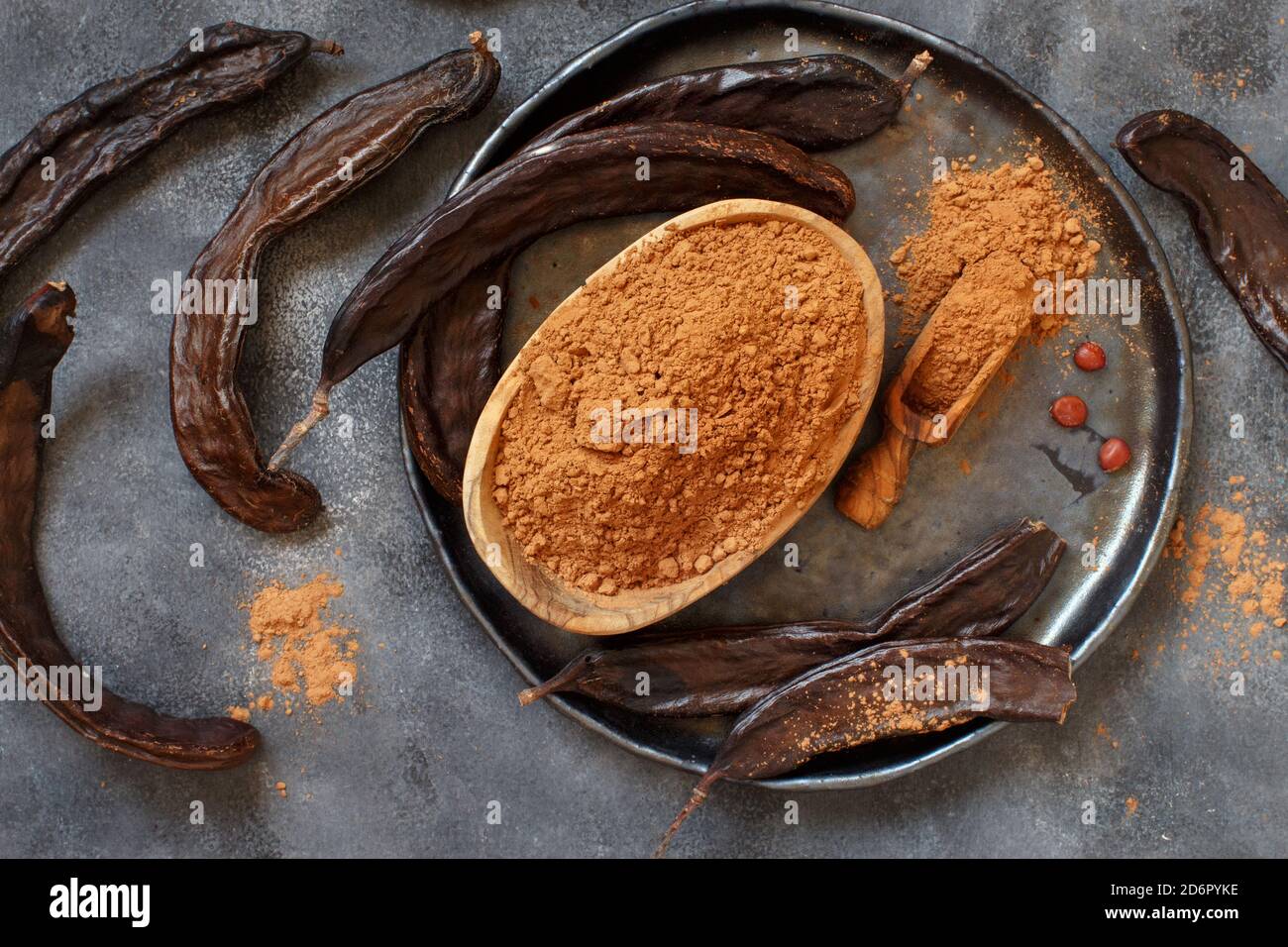 Dry carob pods and powder top view on a grey table Stock Photo - Alamy