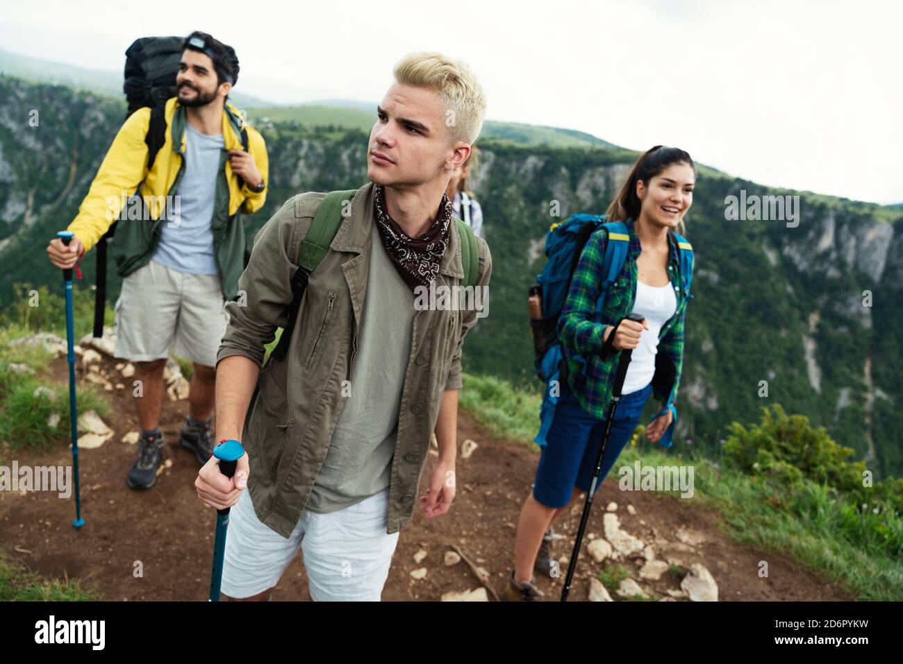 Group of happy friends with backpacks hiking together Stock Photo - Alamy