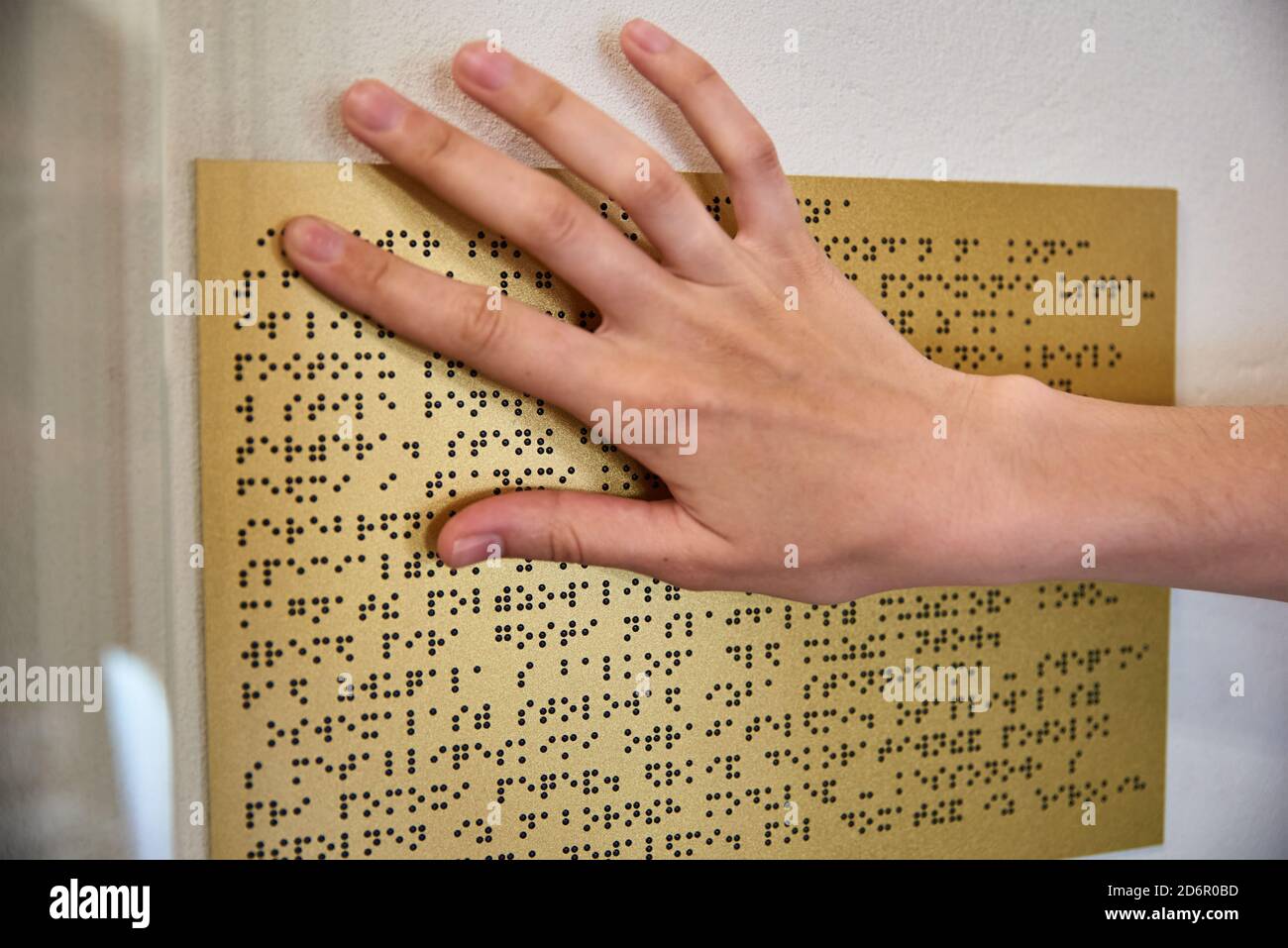 Woman reading braille text on a braille plate Stock Photo - Alamy