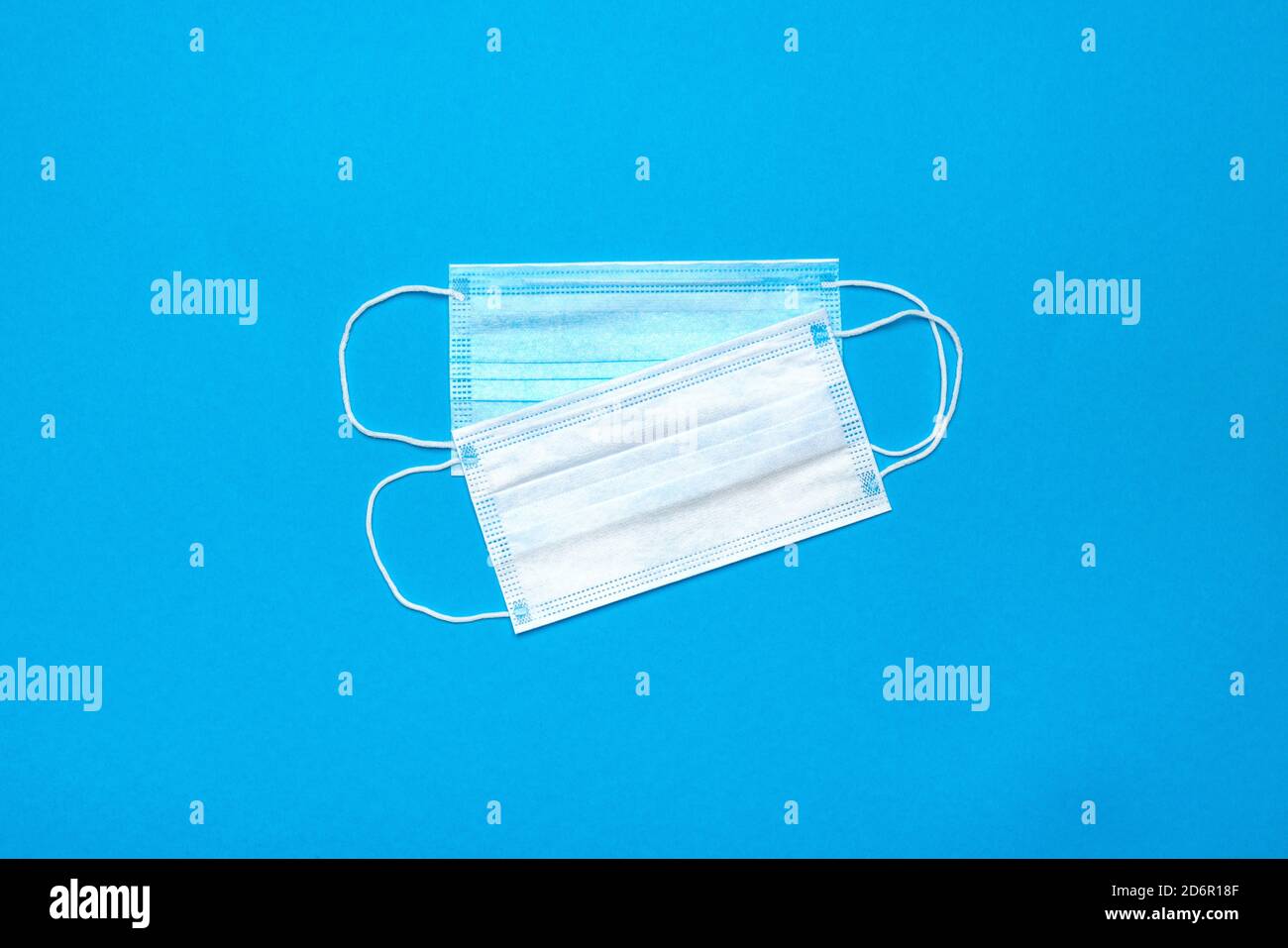 Disposable blue medical face masks on blue background Stock Photo - Alamy