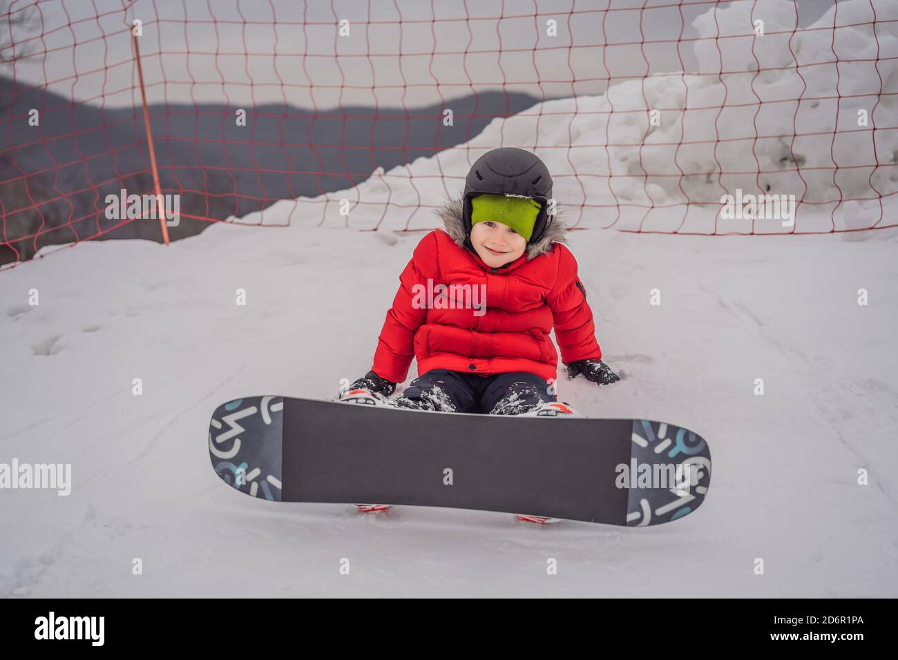 Little cute boy snowboarding. Activities for children in winter ...