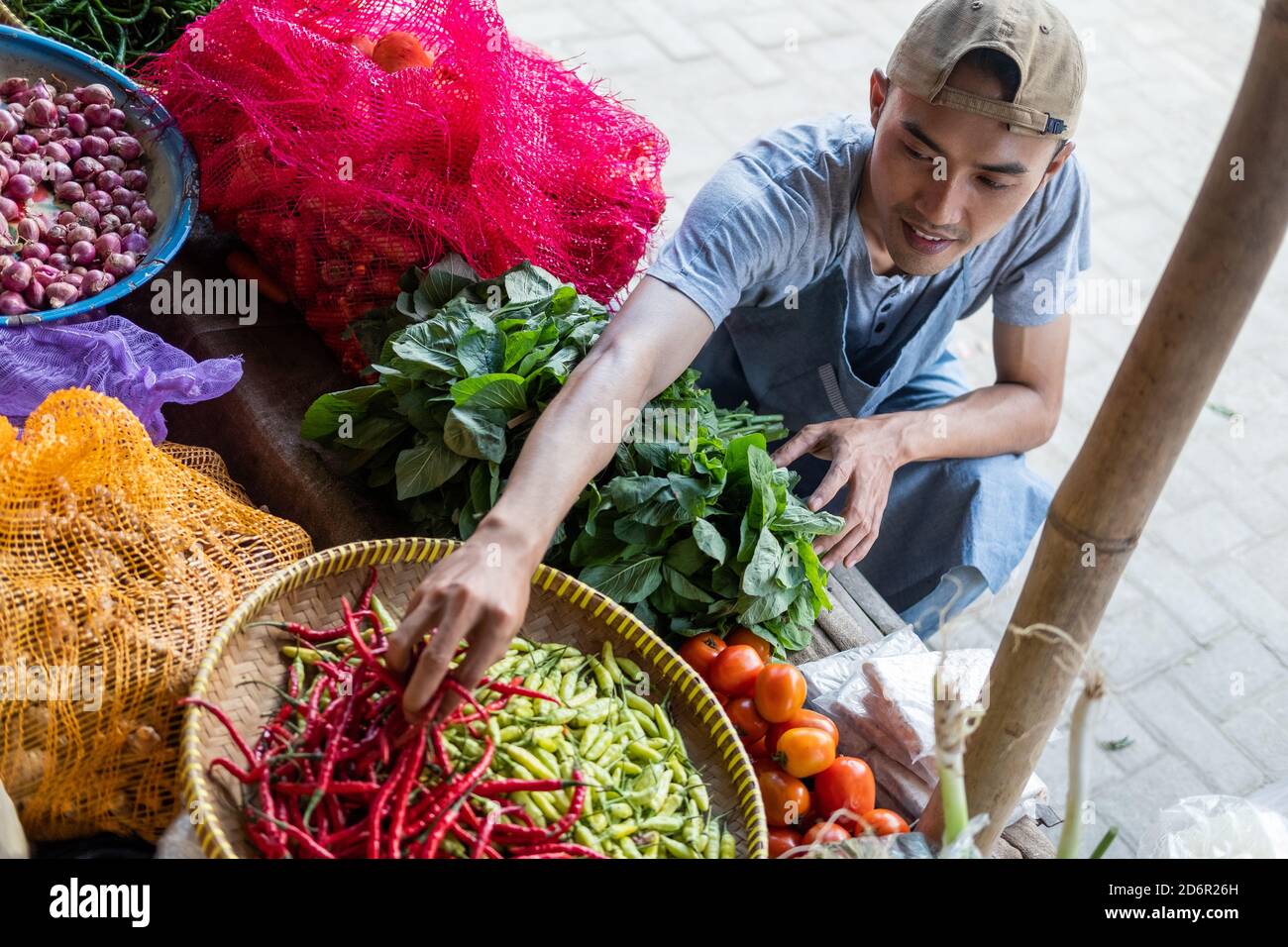 Vegetable stall sales man holding chilies set the display in the ...