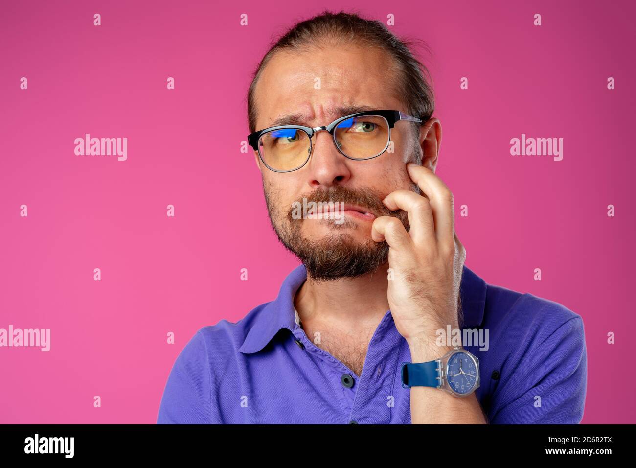 Confused bearded young man thinking about something Stock Photo - Alamy