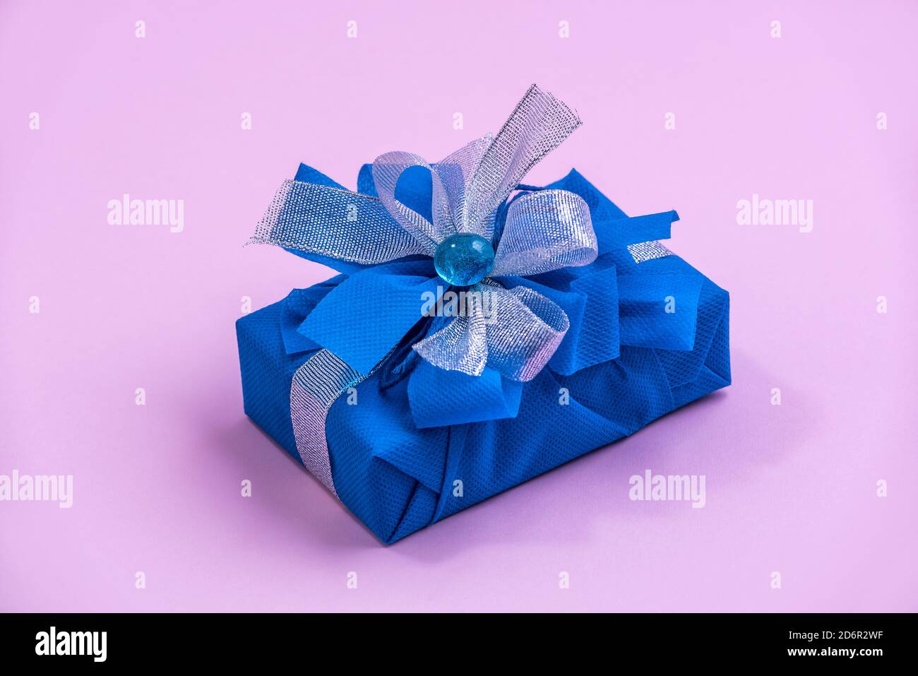 Classic blue surprise gift box with blue and white ribbon, background ...