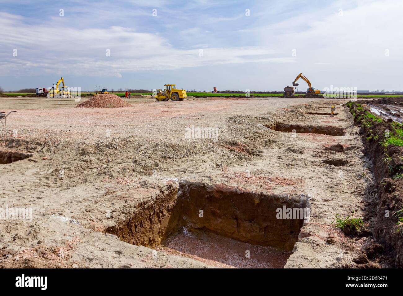 Several freshly excavated and lined square trenches on building site ...