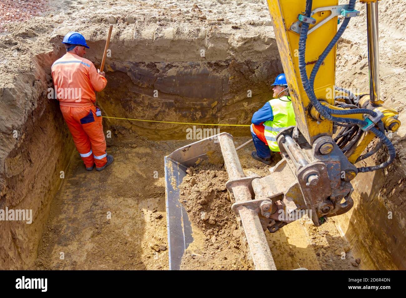 Workers are using metal measure tape, meter to check measurement in ...