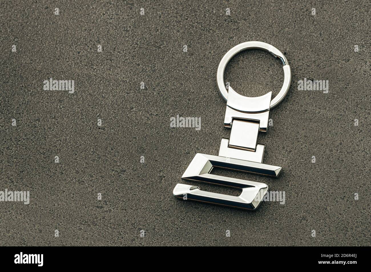 Metal number 5 car key on dark concrete background Stock Photo - Alamy