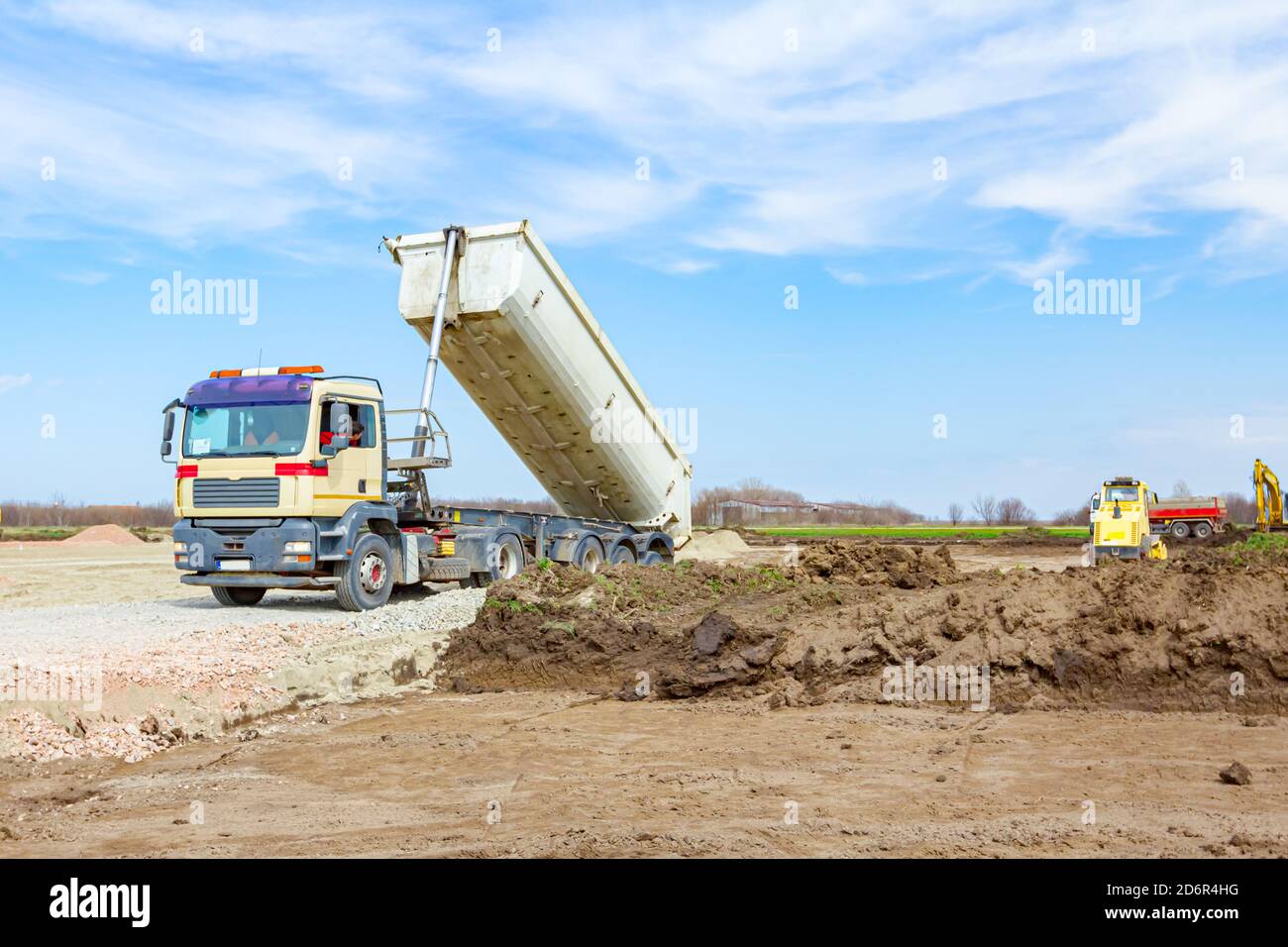 Tipper truck is lifted his trailer to unload cargo, fraction, small ...