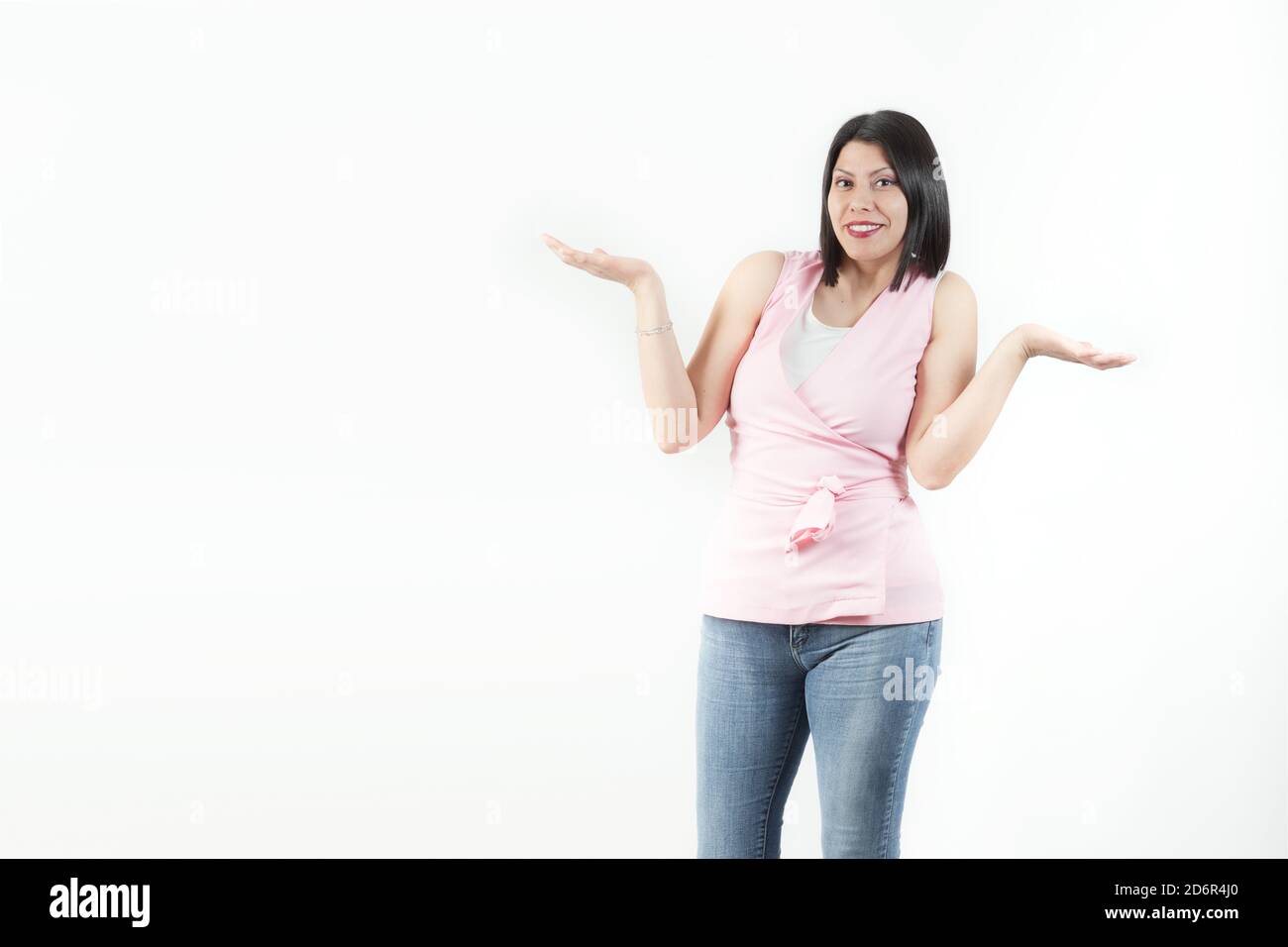 Young woman posing in a questioning attitude on white background Stock ...