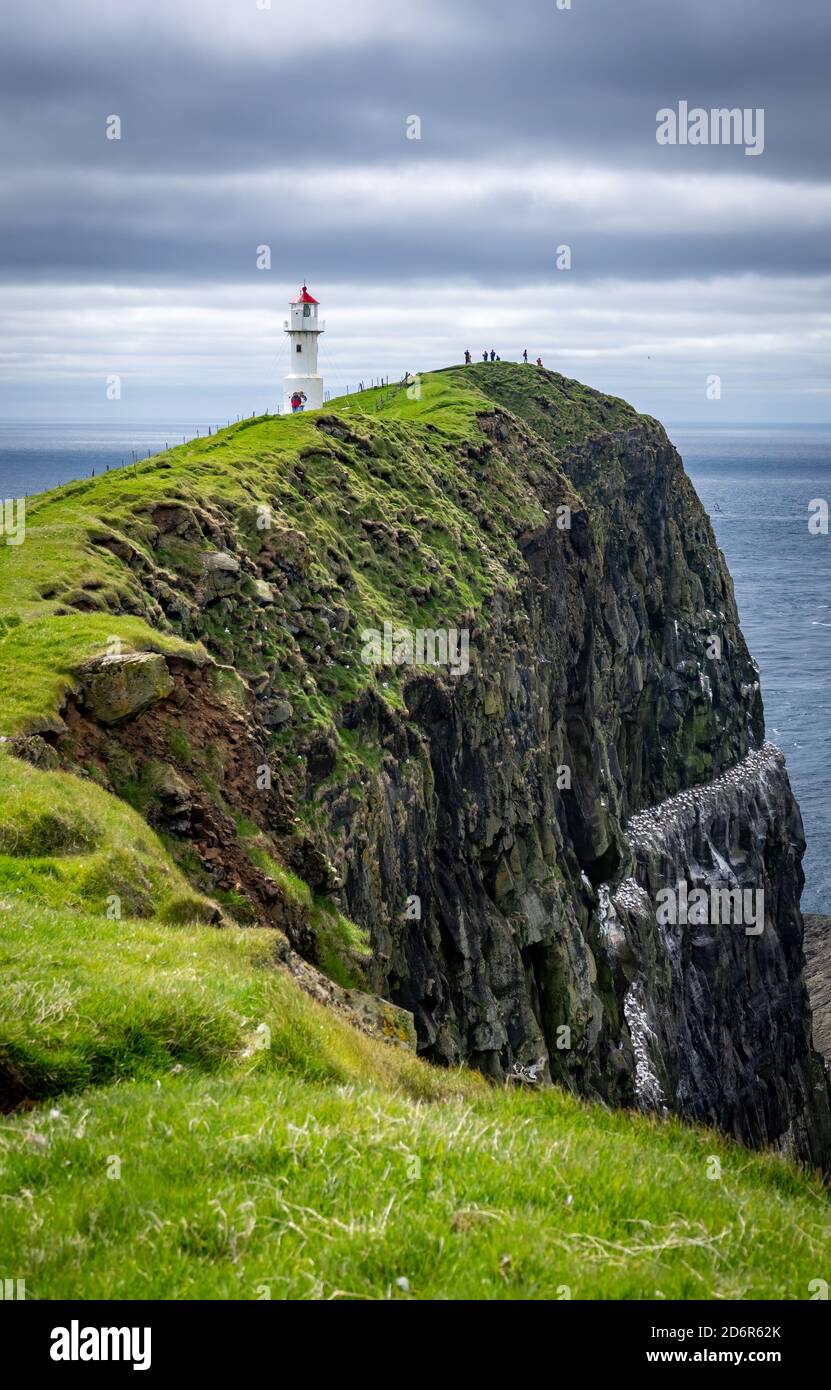 Mykines island lighthouse with tourist and cloudy sky Stock Photo - Alamy