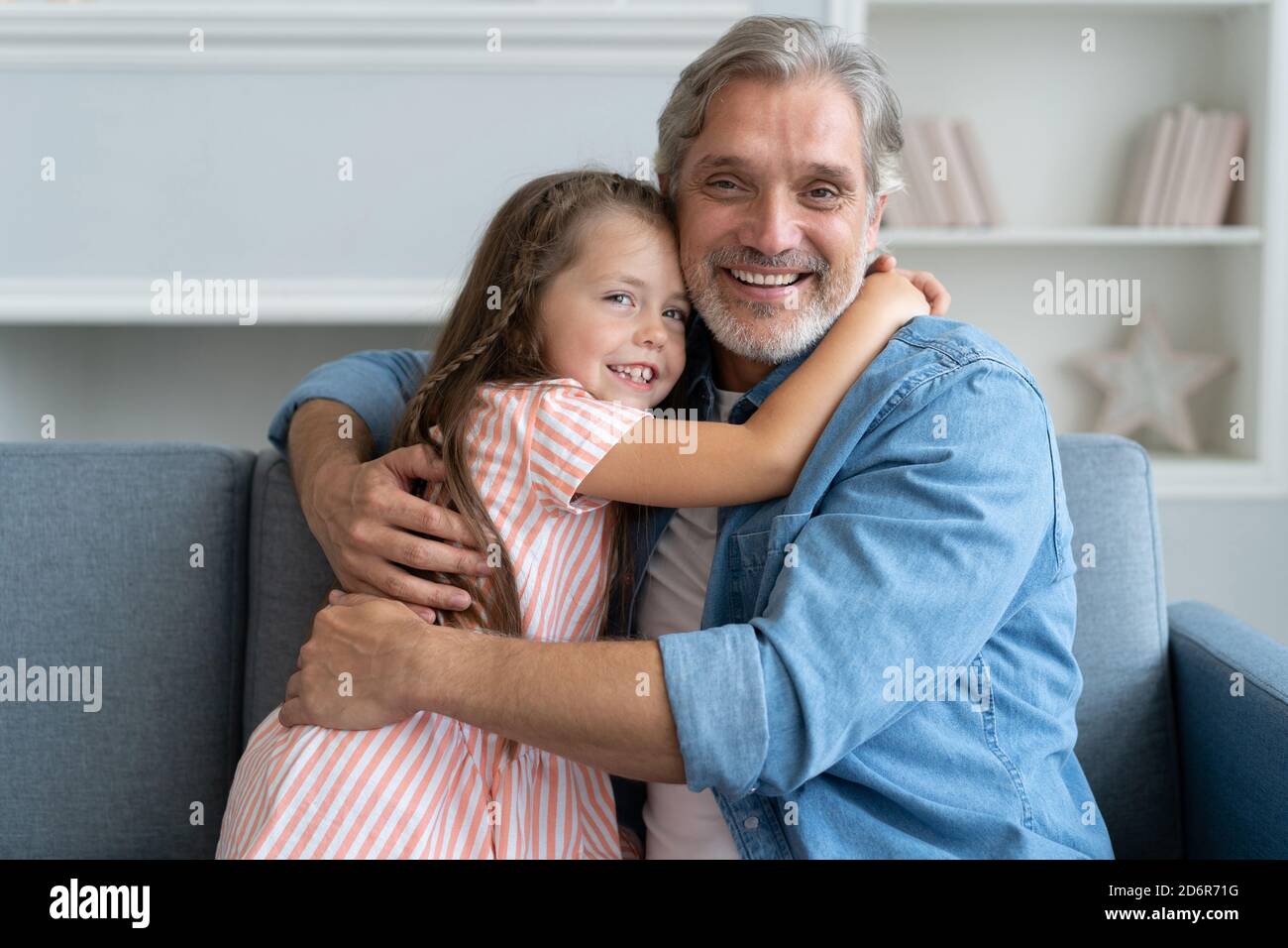 Happy sweet girl hugging her father at home Stock Photo - Alamy