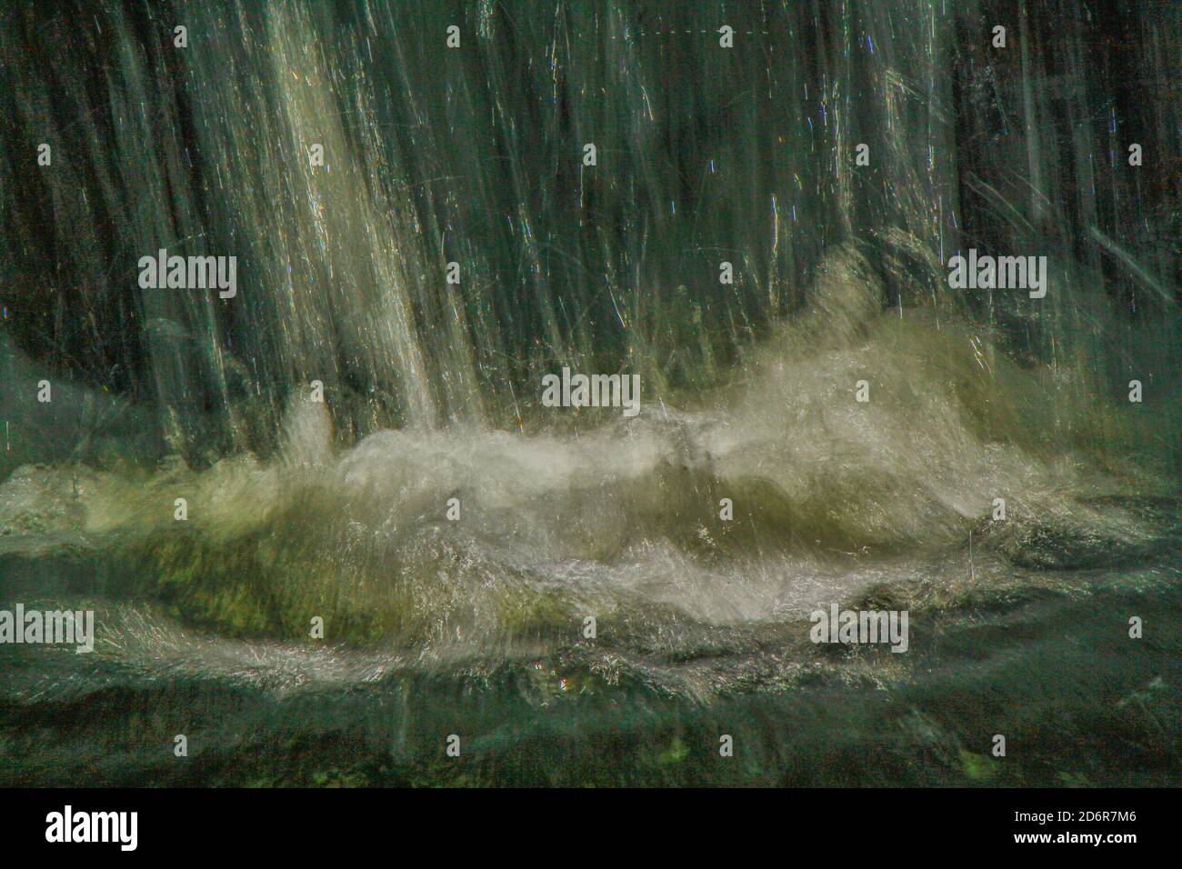 white, silky water froths and foams, churning as it cascades from a ...