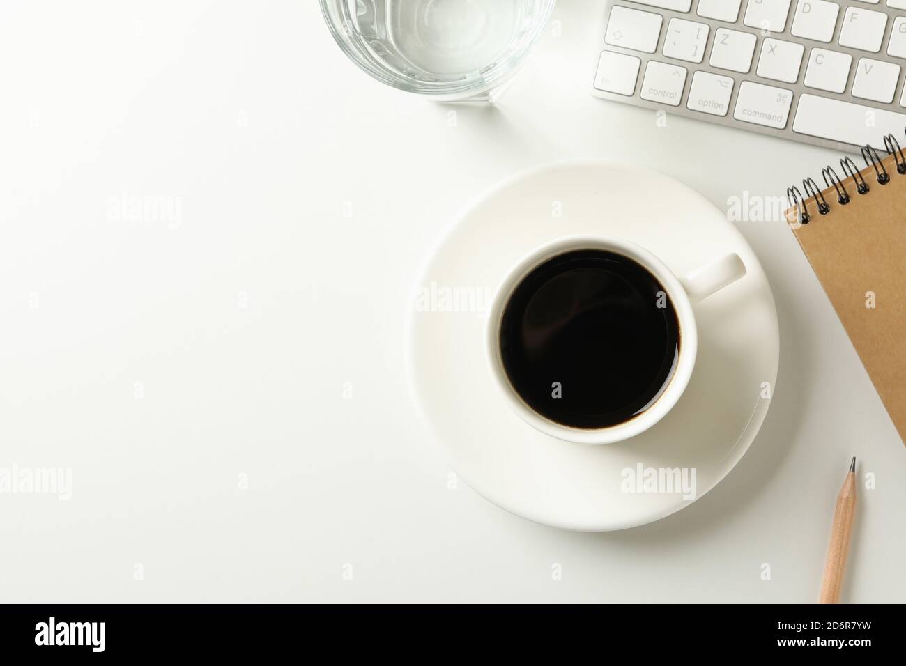 Workplace with cup of coffee on white background Stock Photo - Alamy