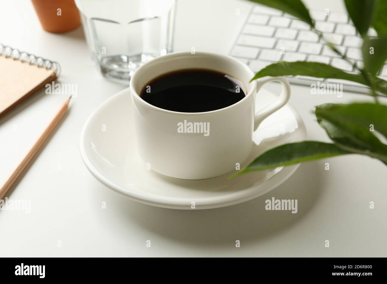 Workplace with cup of coffee on white background Stock Photo - Alamy