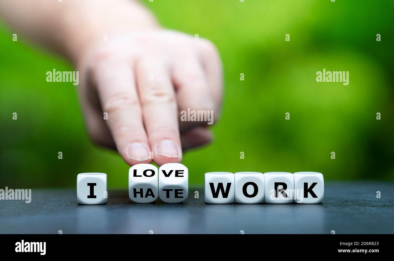 Hand turns dice and changes the expression "I hate work" to "Ilove work ...