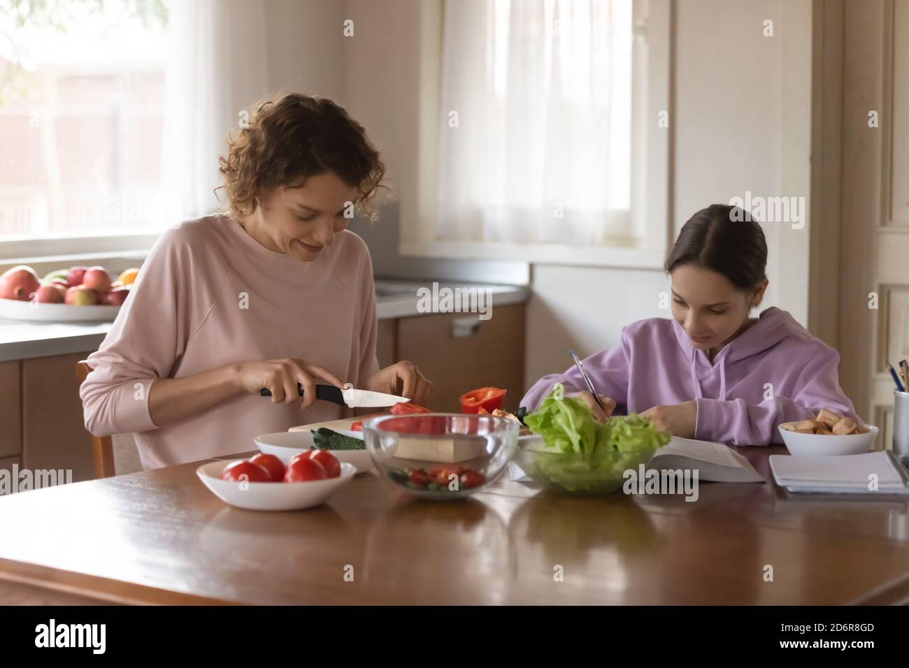 Happy mom and daughter busy with daily routine at home Stock Photo - Alamy