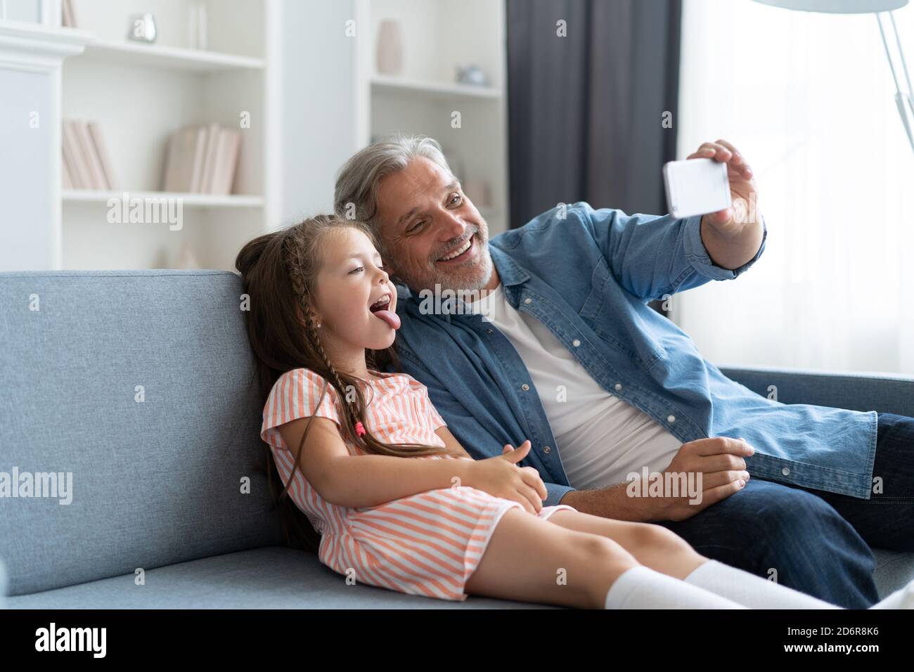 Funny selfie with dad. Self portrait of father and his little daughter ...