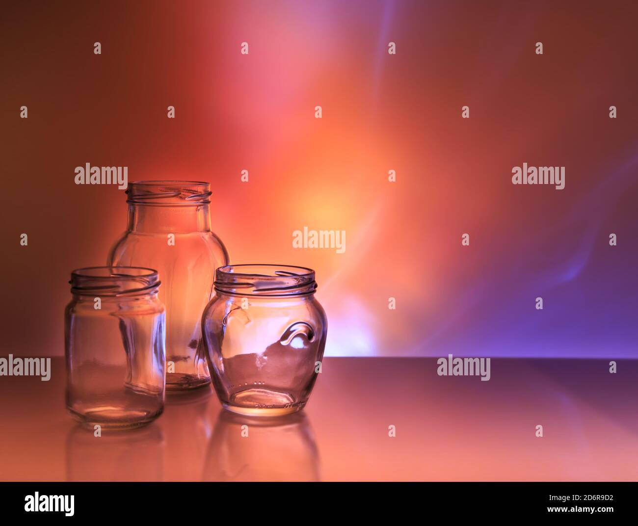 Three glass jars on a colored background, studio shooting Stock Photo ...