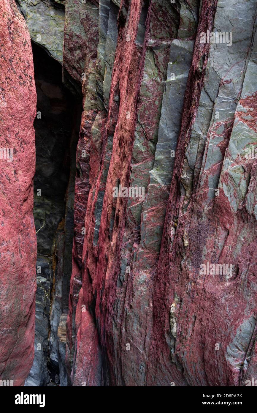 A small cave with red rocks near Combe Martin, England, UK Stock Photo ...