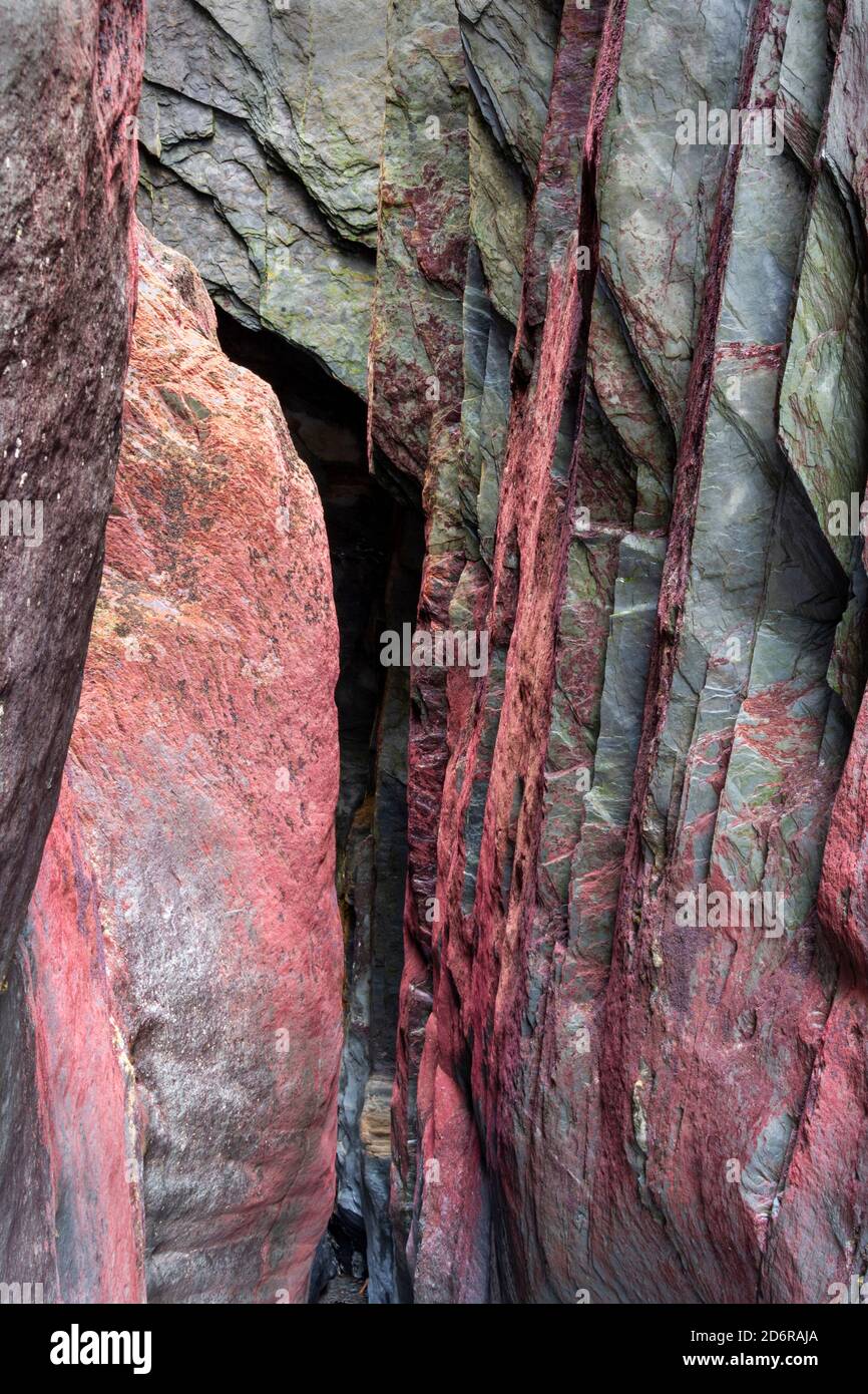A small cave with red rocks near Combe Martin, England, UK Stock Photo ...