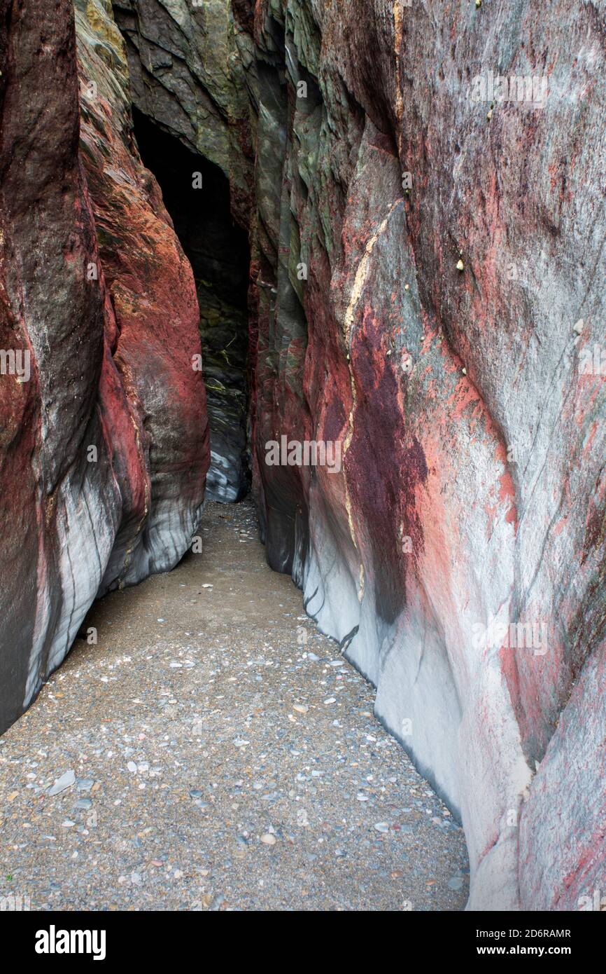 A small cave with red rocks near Combe Martin, England, UK Stock Photo ...