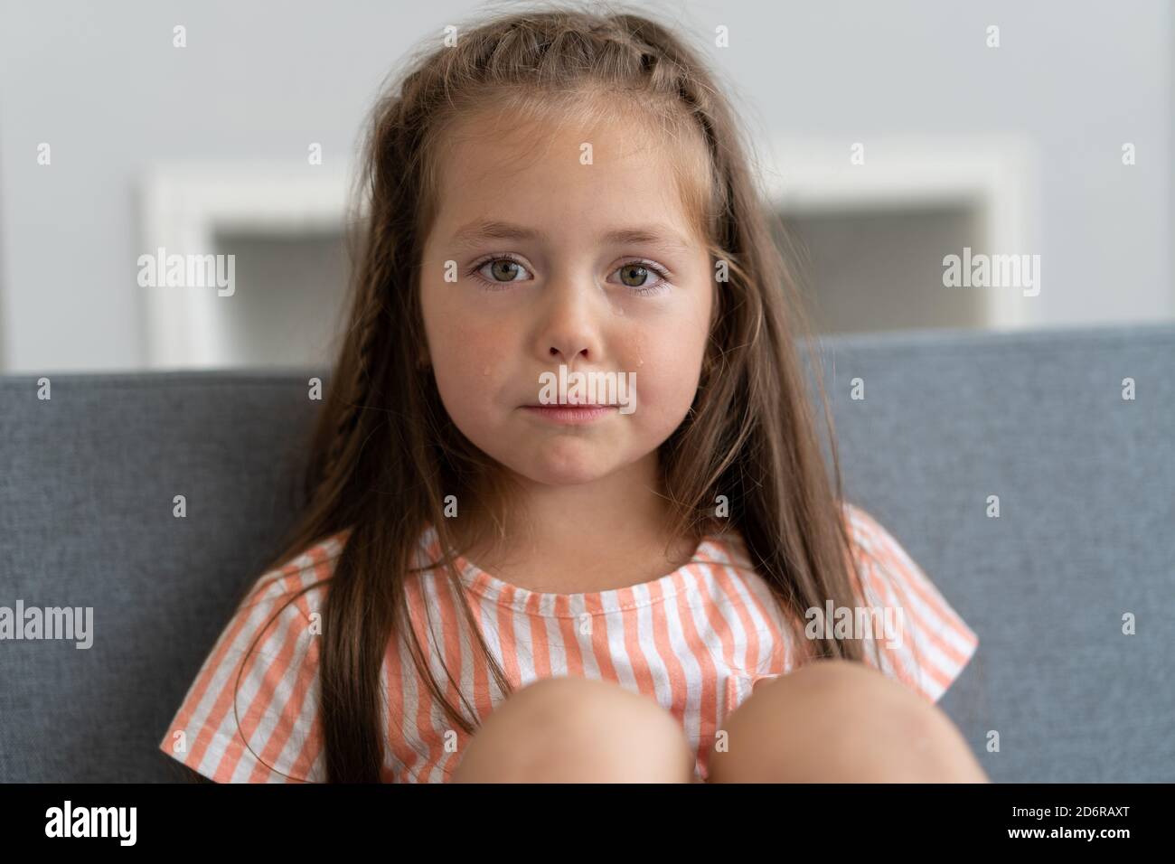 Cute little girl crying at home Stock Photo - Alamy