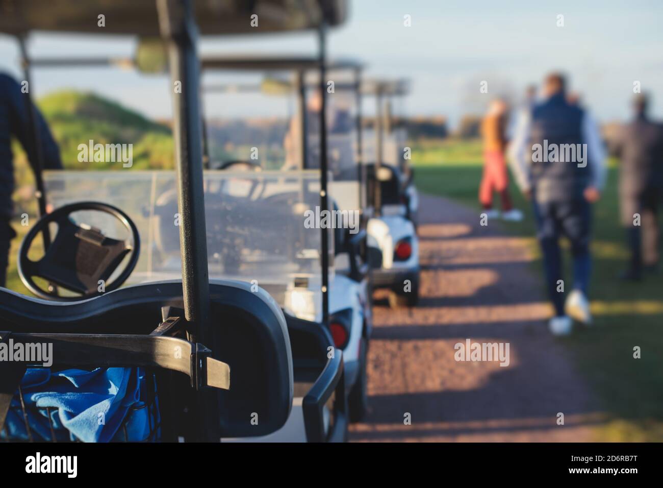 Golf electric cars riding on a golf course in the day, golf carts drive ...