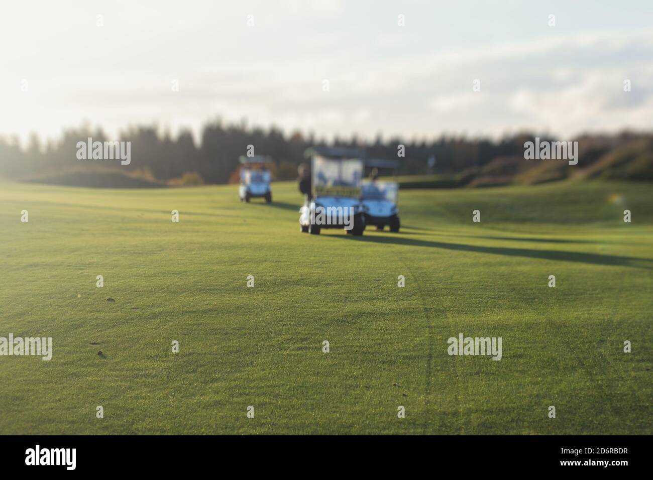 Golf electric cars riding on a golf course in the day, golf carts drive ...