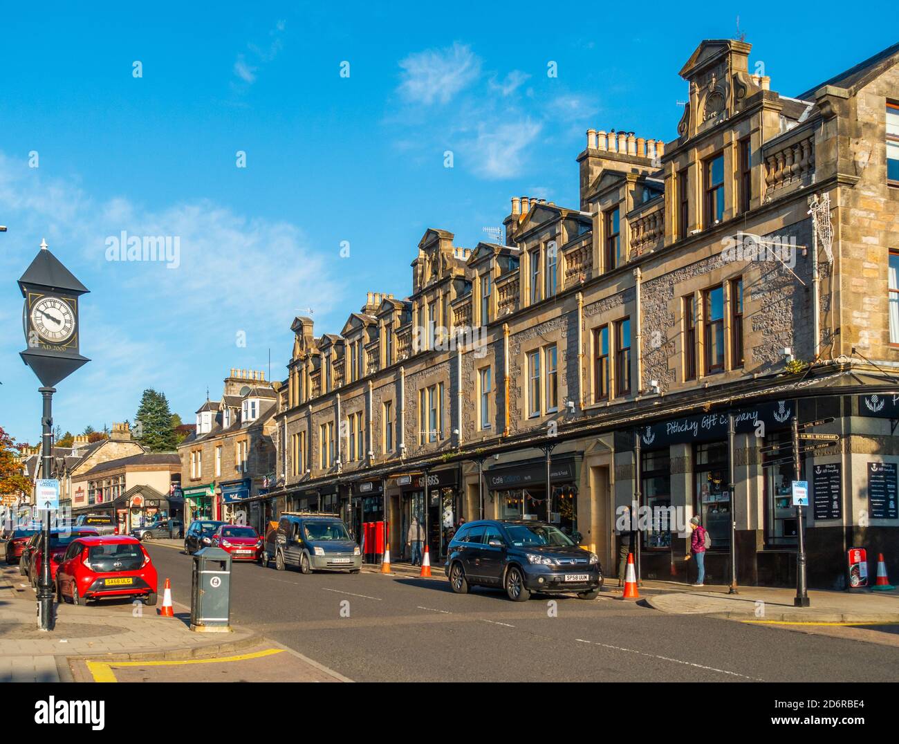 Shops, bars and restaurants in the main street in the town of Pitlochry ...