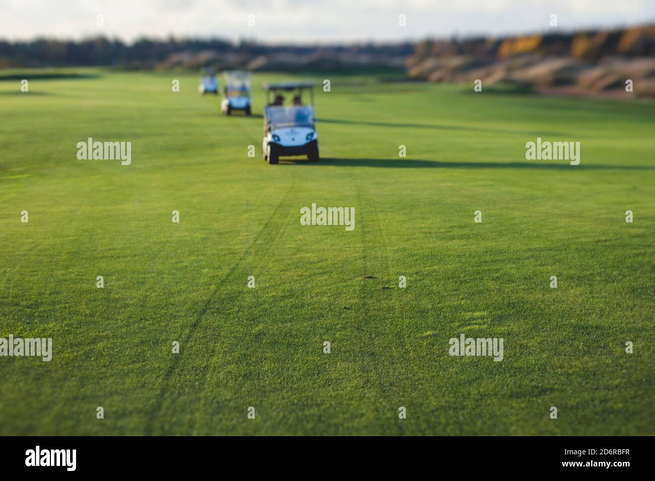 Golf electric cars riding on a golf course in the day, golf carts drive ...