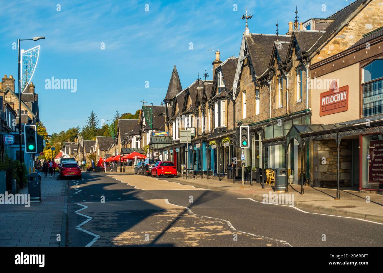 Shops, bars and restaurants in the main street in the town of Pitlochry ...