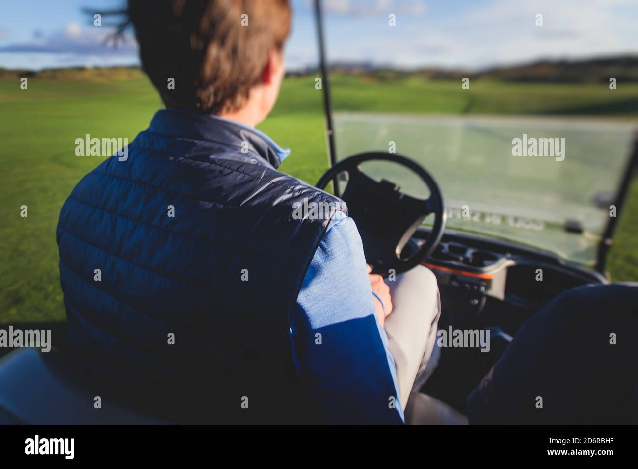 Golf electric cars riding on a golf course in the day, golf carts drive ...
