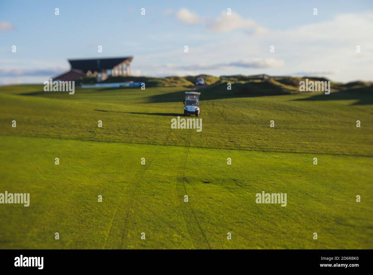 Golf electric cars riding on a golf course in the day, golf carts drive ...