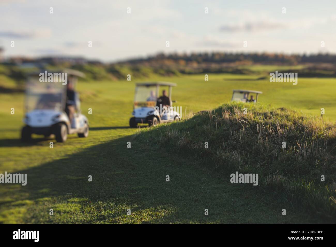 Golf electric cars riding on a golf course in the day, golf carts drive ...
