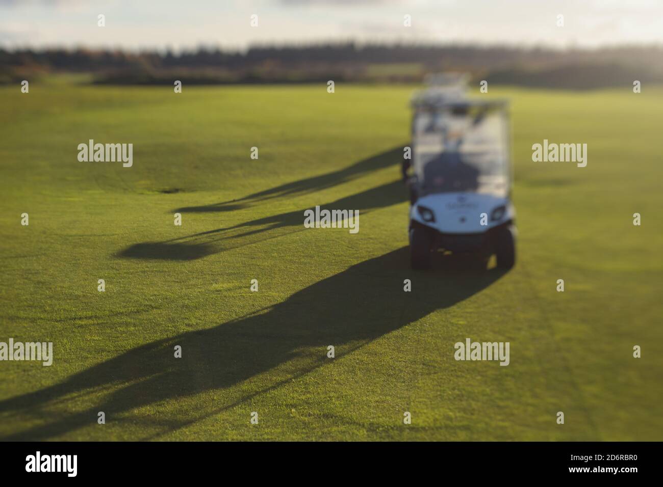 Golf electric cars riding on a golf course in the day, golf carts drive ...