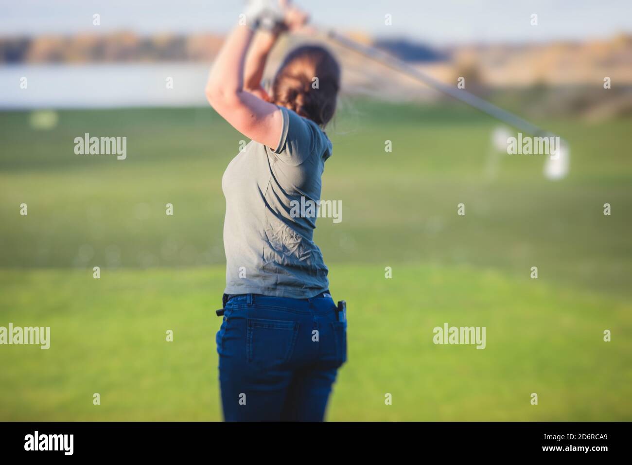 Female golfer girl player practicing and training golf swing on driving ...