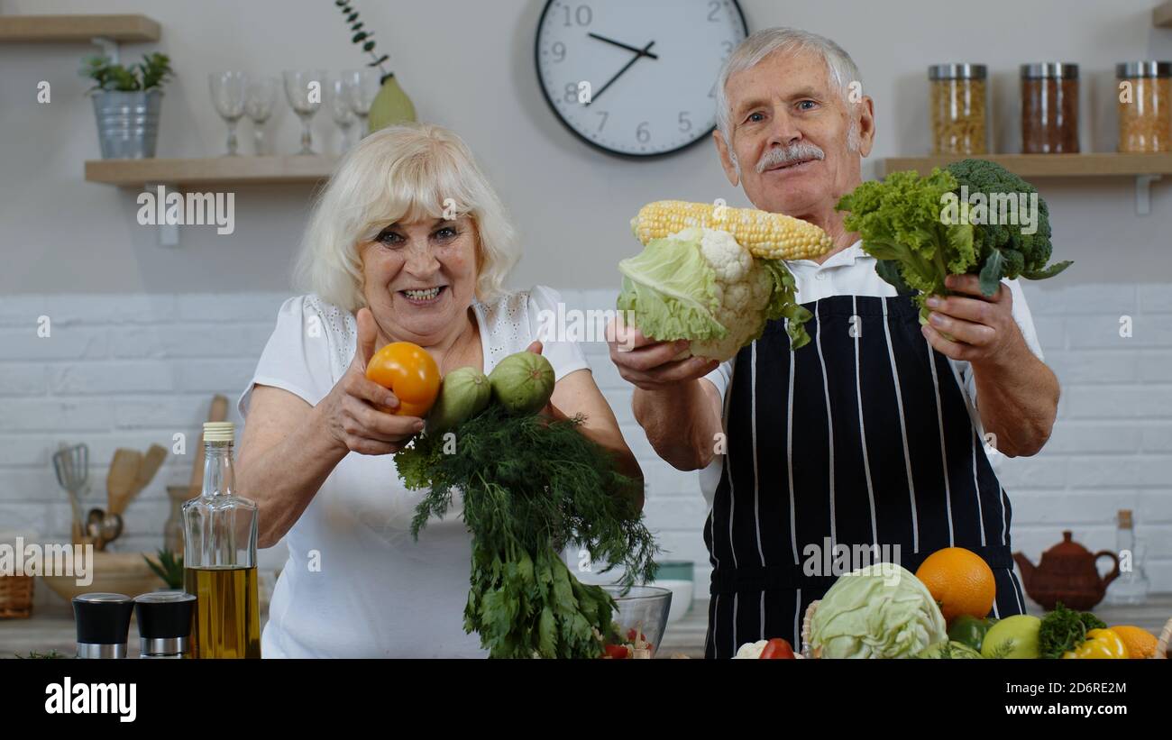 Senior grandparents couple in kitchen. Mature man and woman ...