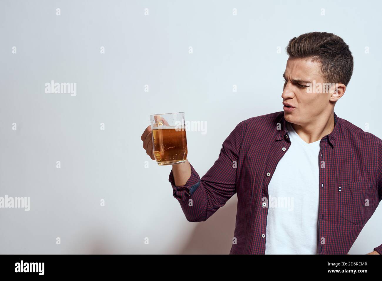 Drunk man with a mug of beer vacation alcohol lifestyle in a red shirt ...