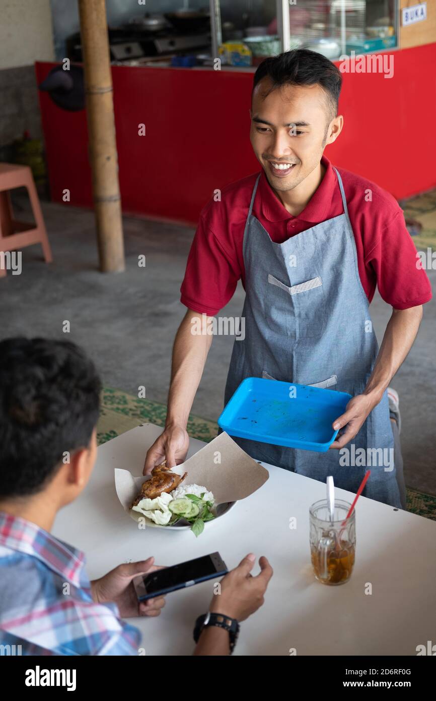 Man serving food canteen hi-res stock photography and images - Alamy