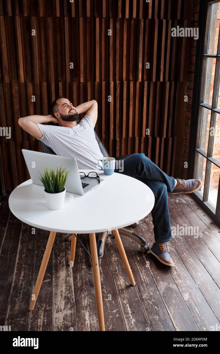 Smiling happy businessman in glasses and white shirt relaxing in office ...