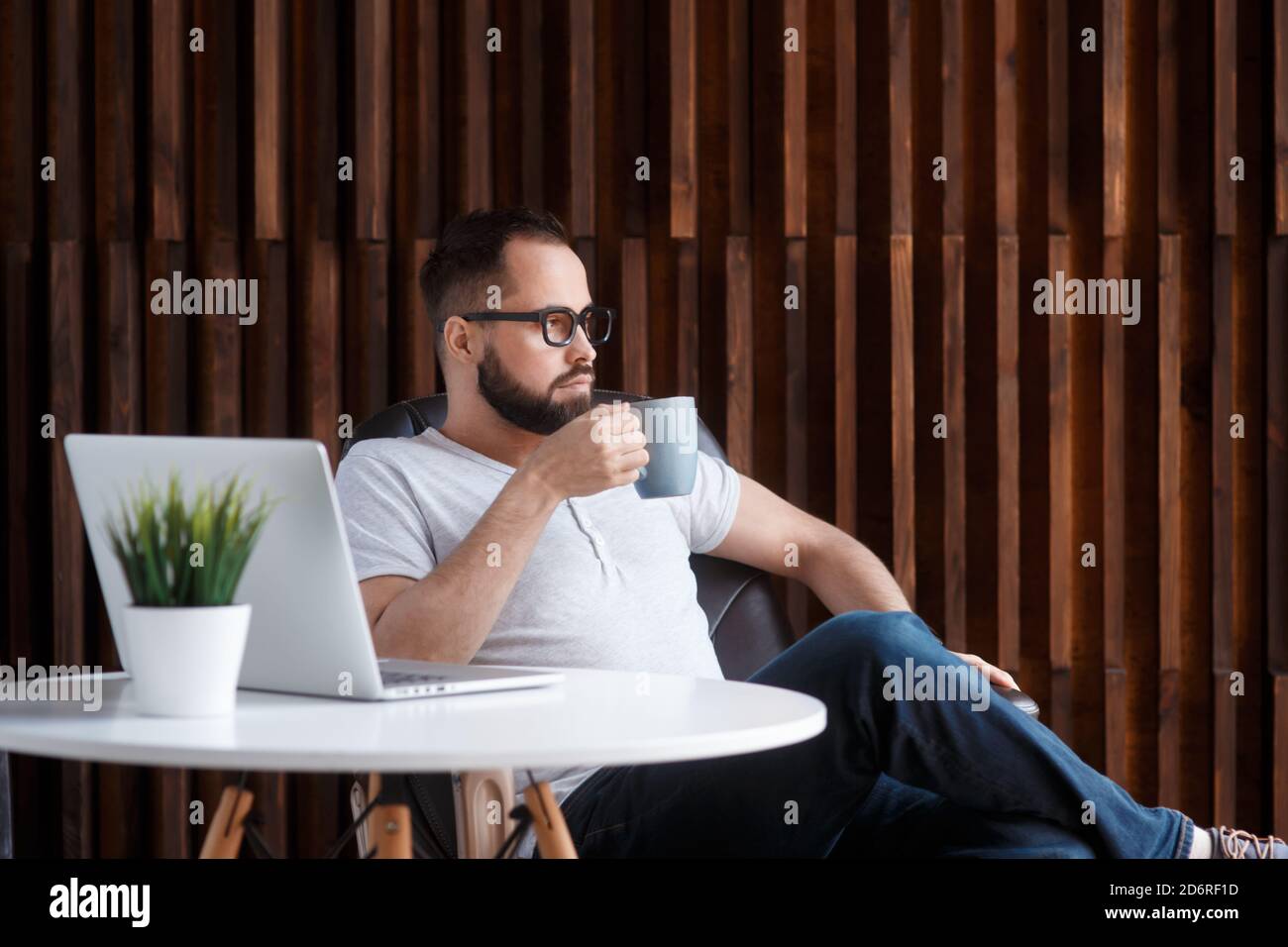 Young successful bearded businessman freelancer in office coworking ...