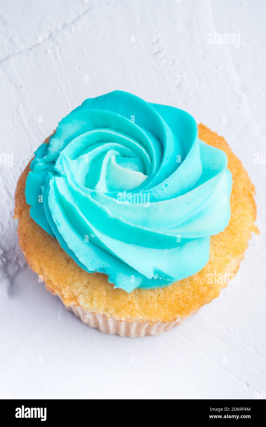Delicious Cupcake or muffin decorated with blue whipped cream cheese ...