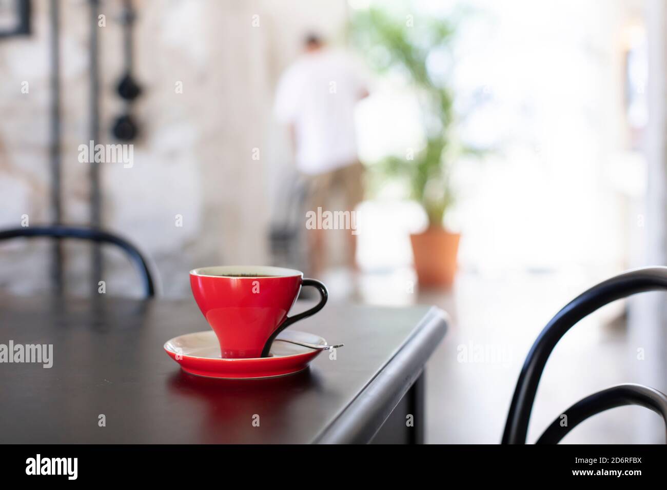 Red Coffee Cup On Black Table at a Cafe Stock Photo - Alamy