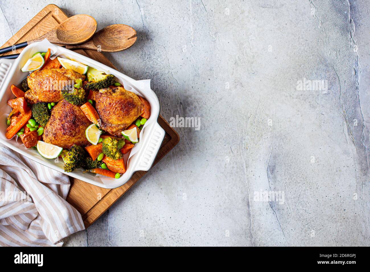 Baked chicken with vegetables, gray background Stock Photo - Alamy