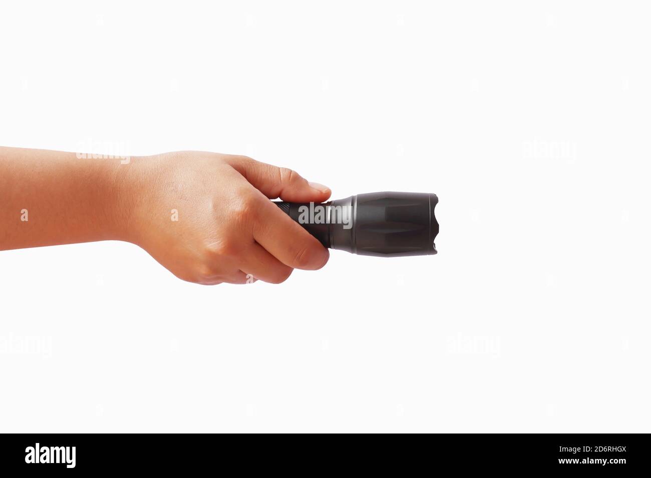 Black flashlight in human hands, isolated on a white background with ...