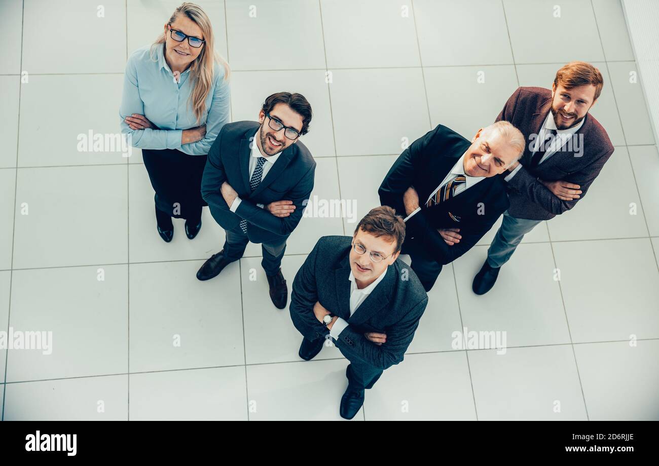 top view. a group of smiling business people looking at the camera ...