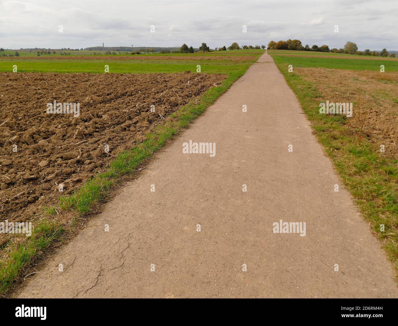 long straight way through plowed fields in autumn in Germany Stock ...
